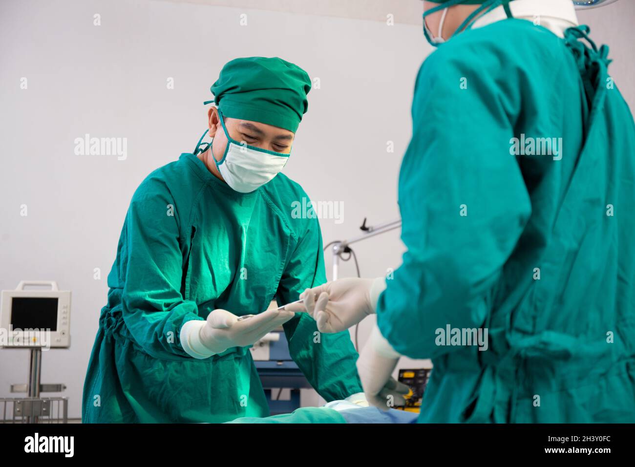 Doctor sending instrument with surgeon with rescue and save patient in ...
