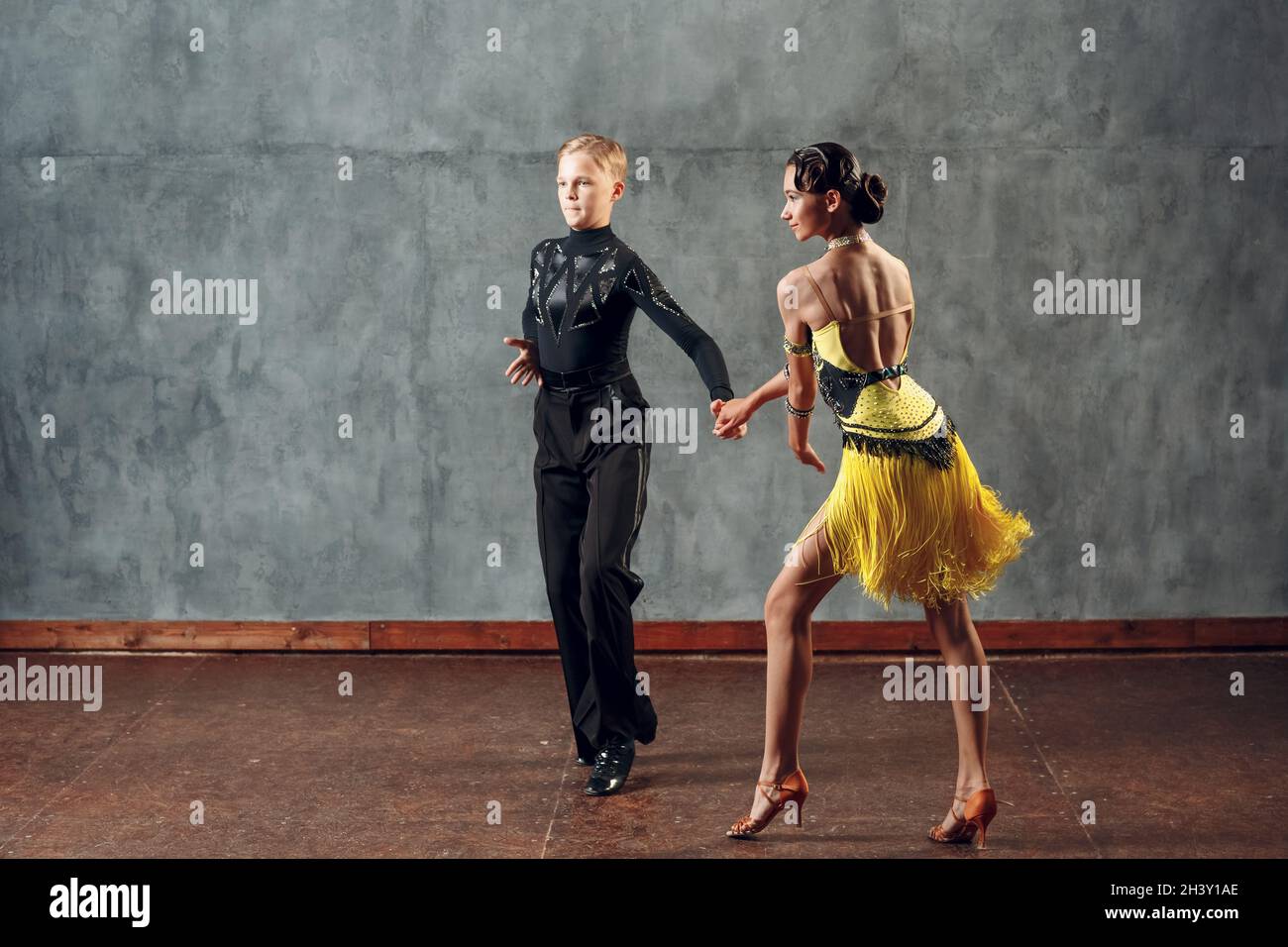 Young couple dancers dancing ballroom dance cha-cha-cha Stock Photo - Alamy