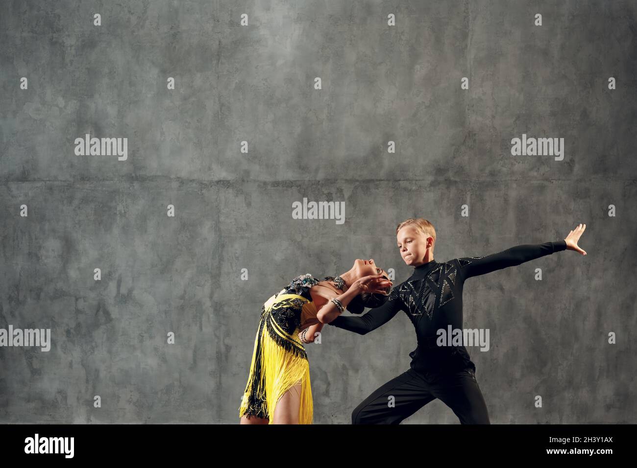 Young couple dancers dancing ballroom dance cha cha cha Stock Photo - Alamy