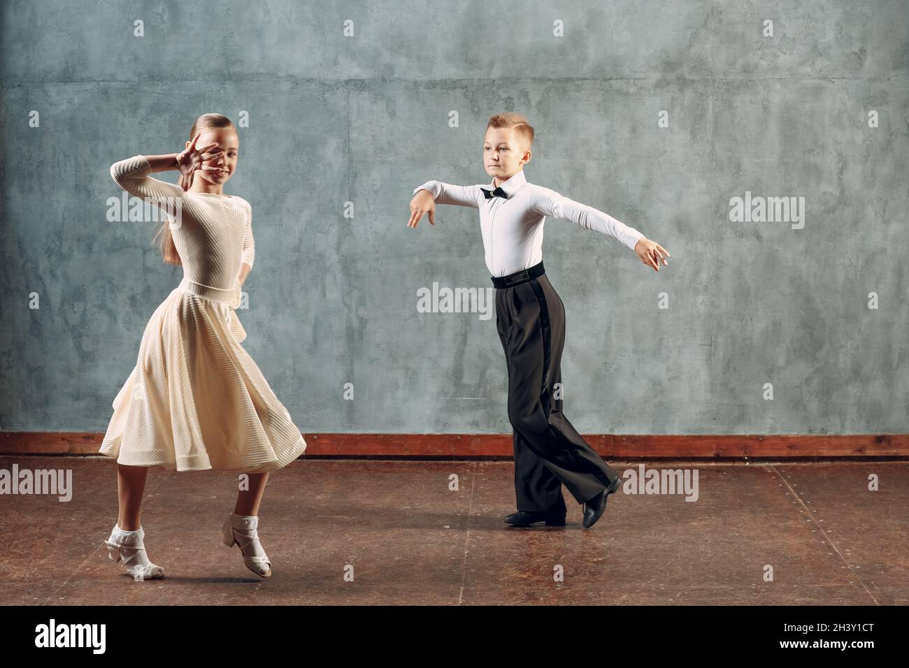 Young dancers boy and girl dancing in ballroom dance Samba Stock Photo ...