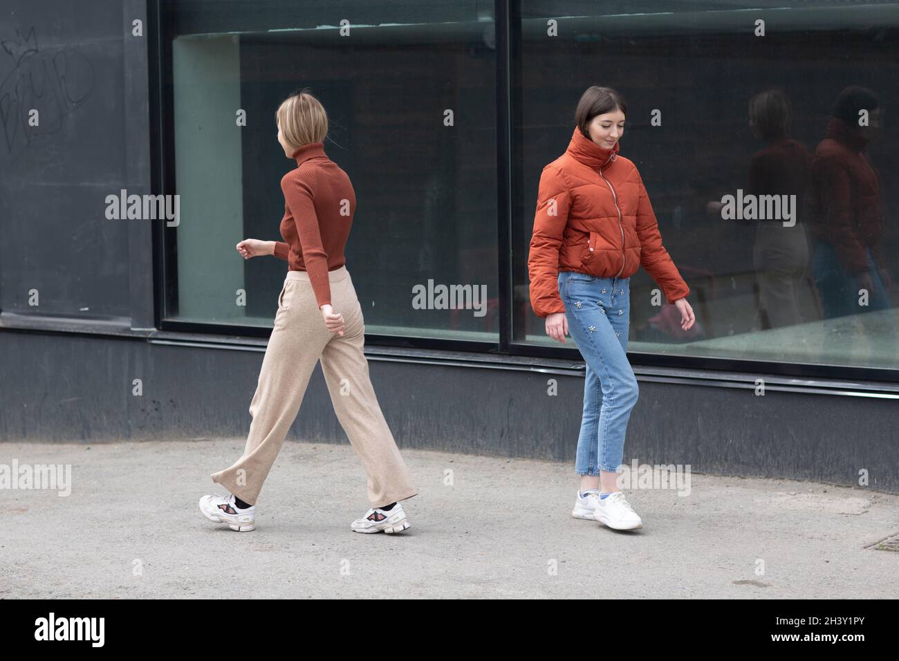 Two girls walking together hi-res stock photography and images - Alamy