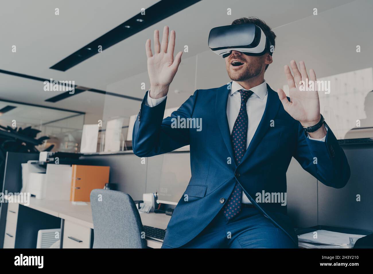 CEO man in VR headset interacting with virtual objects or interface ...