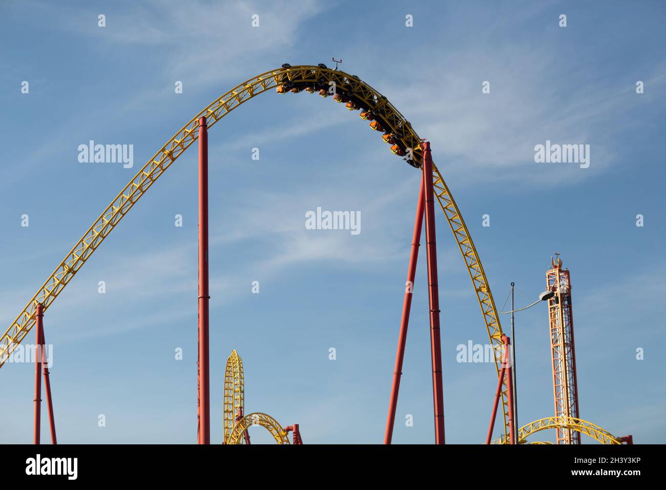 Rollercoaster Ride against blue sky. Roller coaster in the amusement ...