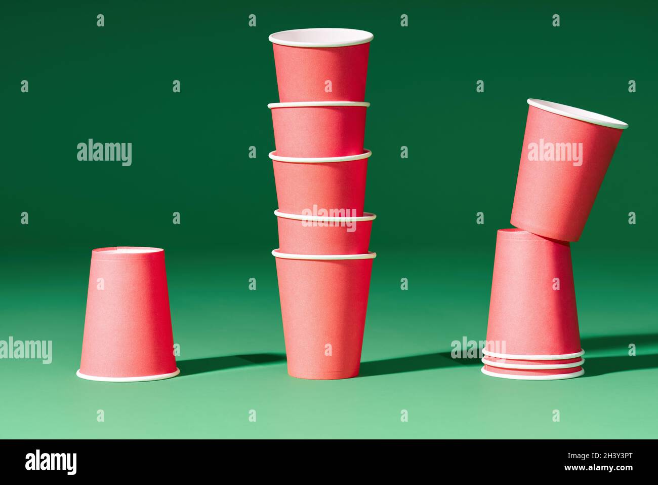 Set of red paper cups on green background Stock Photo - Alamy