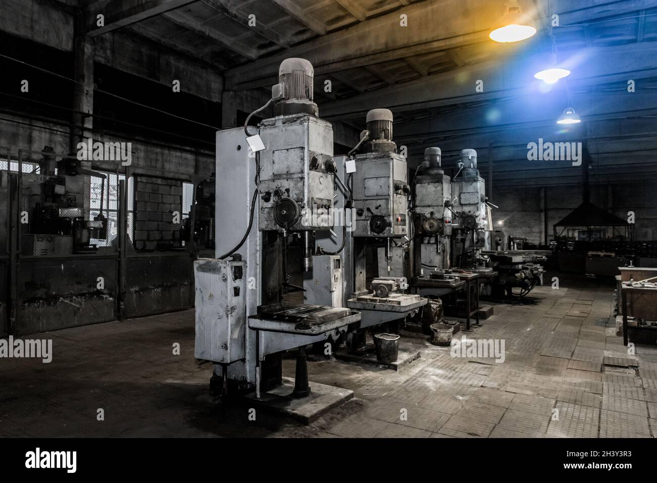 Old vertical milling machines equipment with flanged electric motors ...