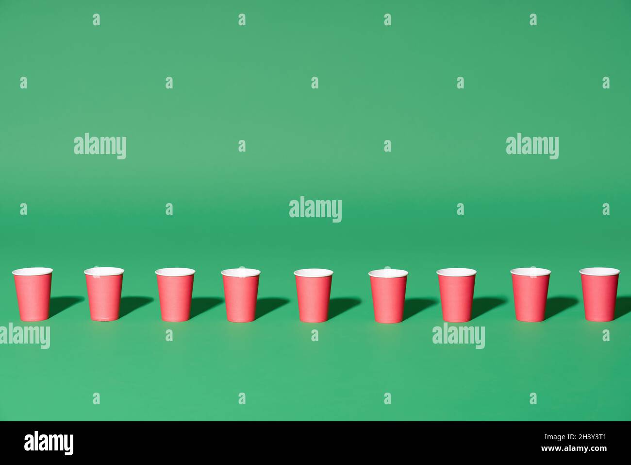 Row of red paper cup on green background with copy space Stock Photo ...