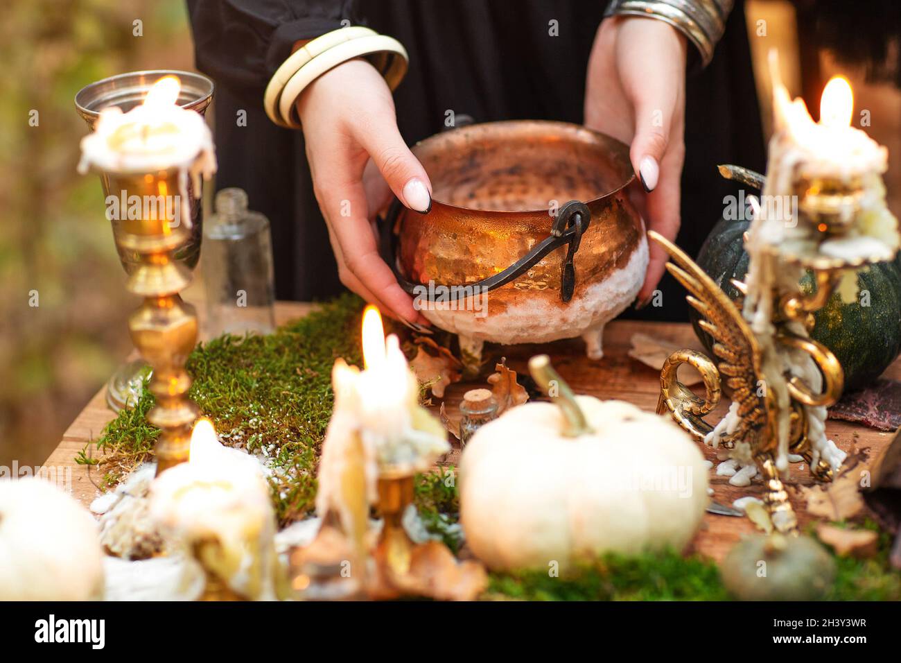 Young witch writing spells in forest Stock Photo - Alamy
