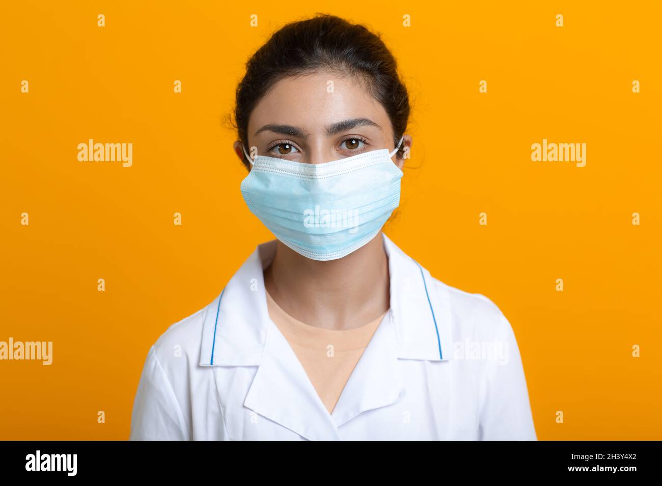 Portrait of indian doctor woman in white medical gown isolated on ...
