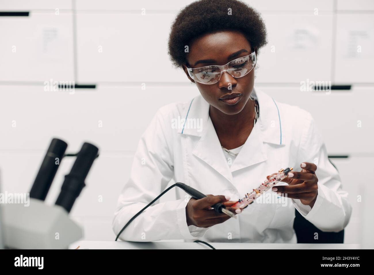 Scientist african american woman working in laboratory with electronic ...