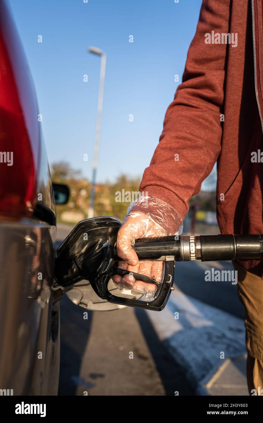 Hand holding gas fuel pump nozzle hi-res stock photography and images ...