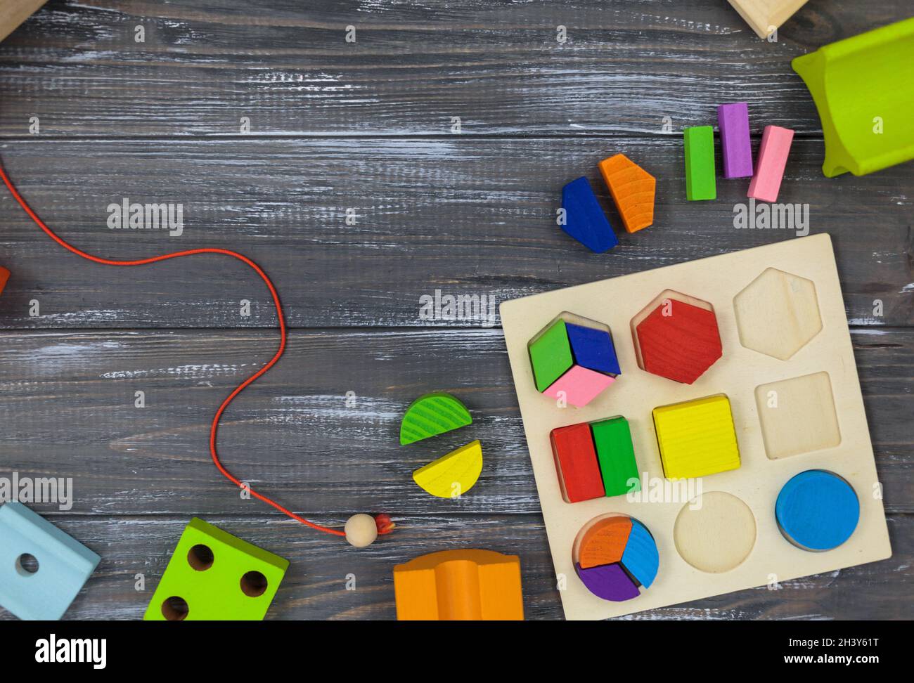 Multicolored fractions, blocks, toys on a gray wooden table. Back to ...