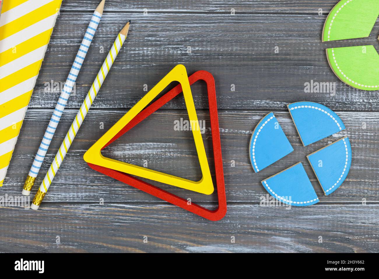 Multicolored fractions, blocks, notebook on a gray wooden table. Back ...