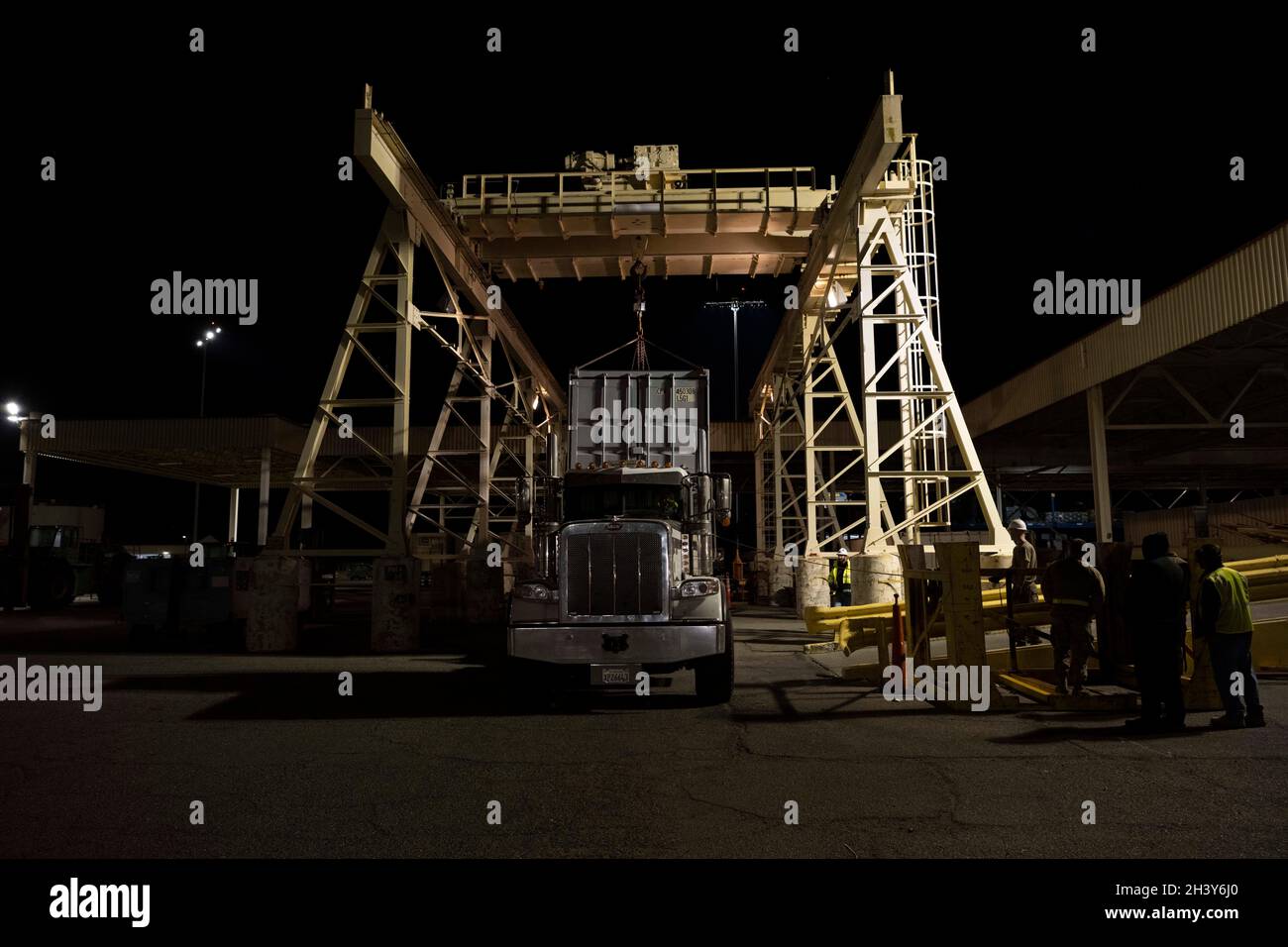 Members of the 60th Aerial Port Squadron prepare to use a crane to lift ...
