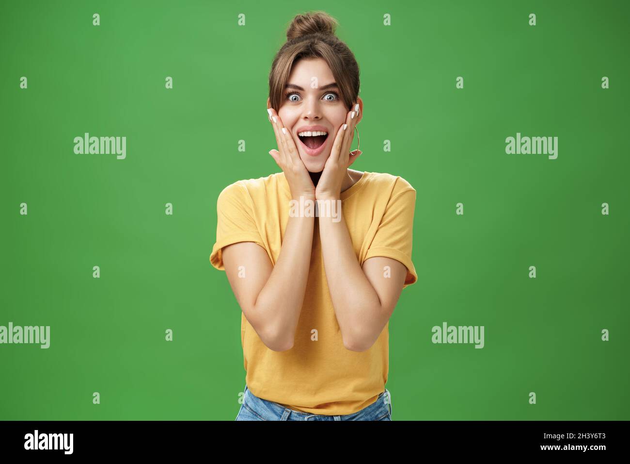 Indoor shot of excited and surprised energized attractive glamorous ...