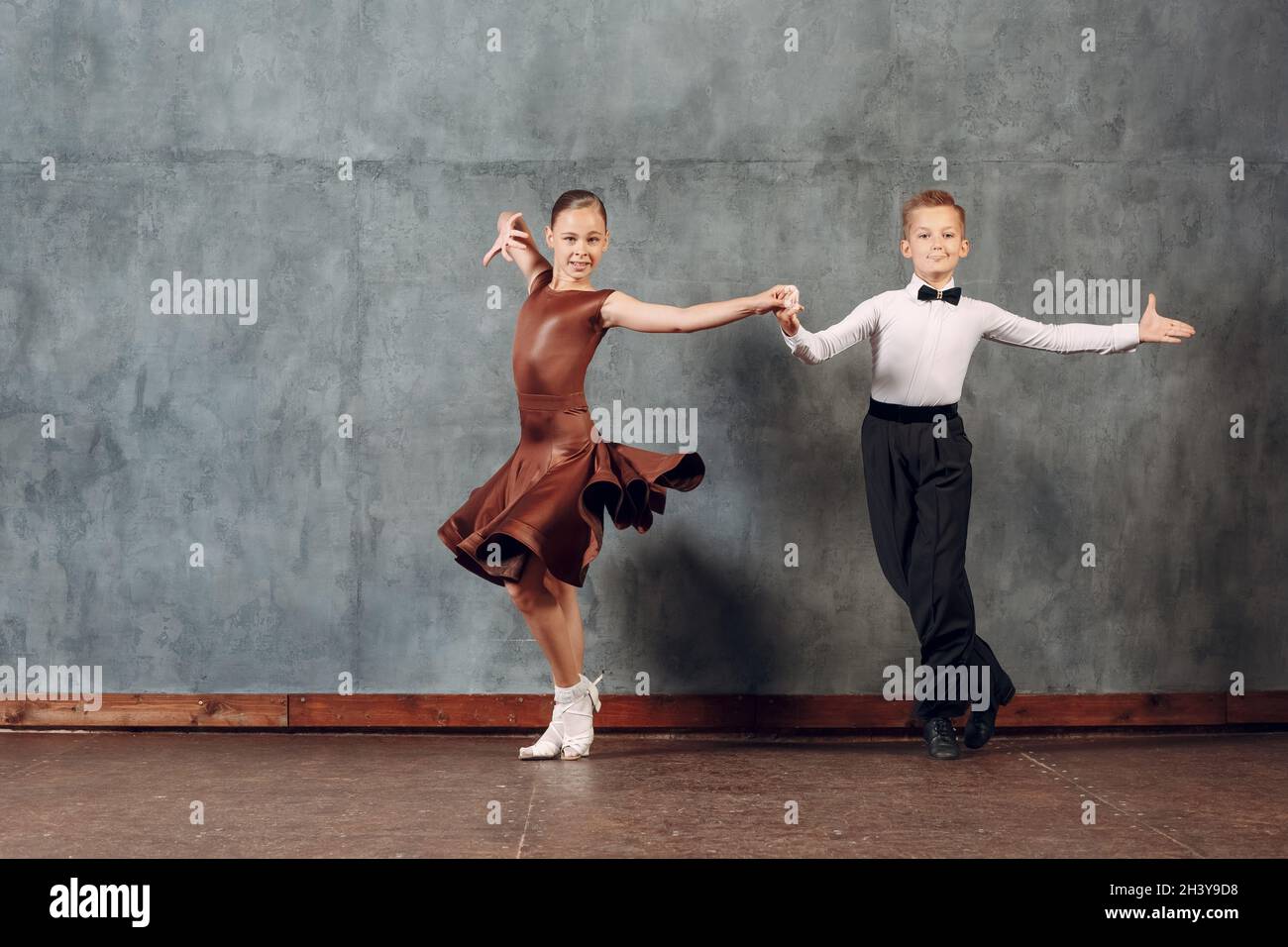 Young dancers boy and girl dancing in ballroom dance Samba Stock Photo ...