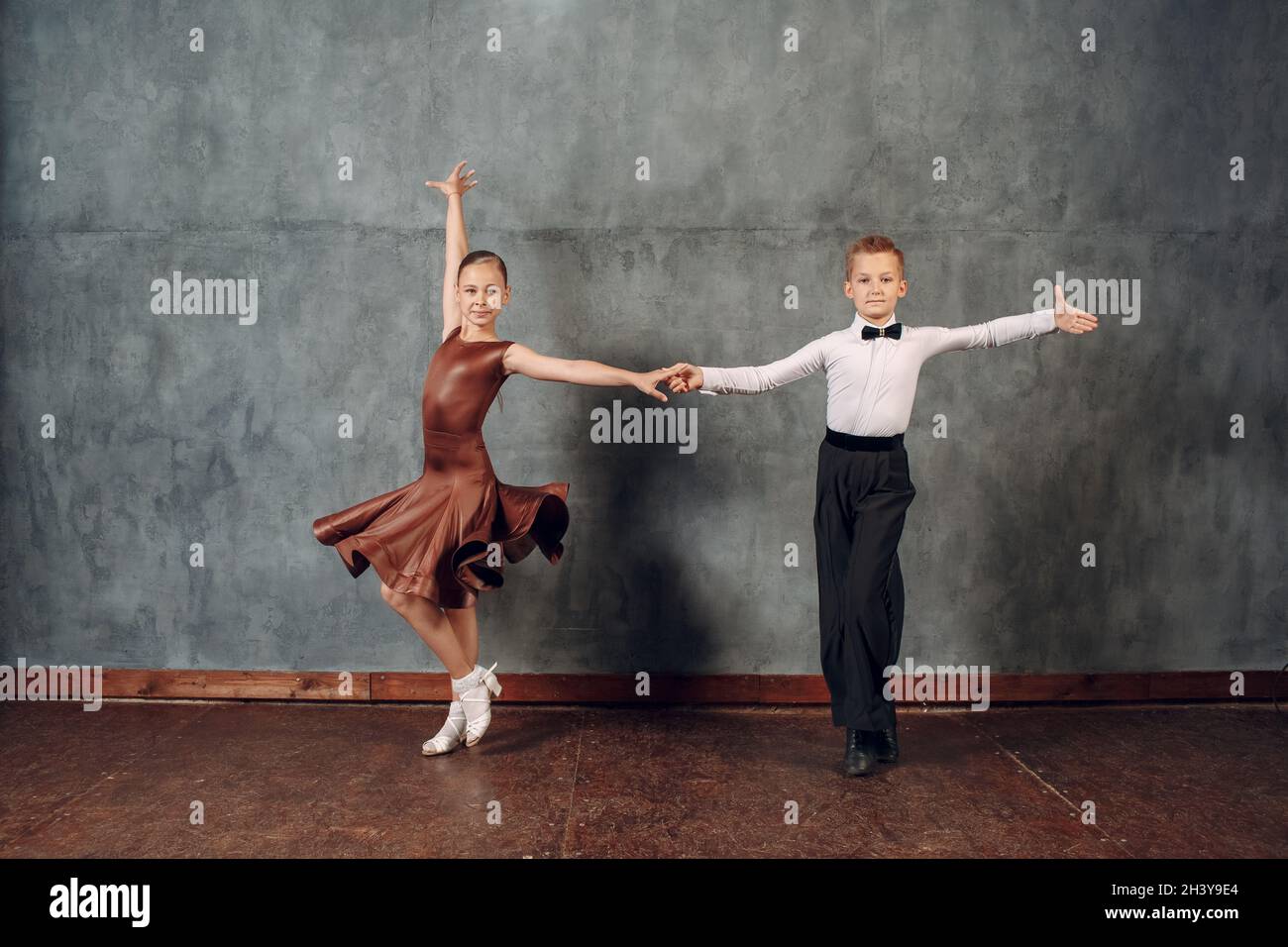 Young dancer boy and girl dancing in ballroom dance Samba Stock Photo ...