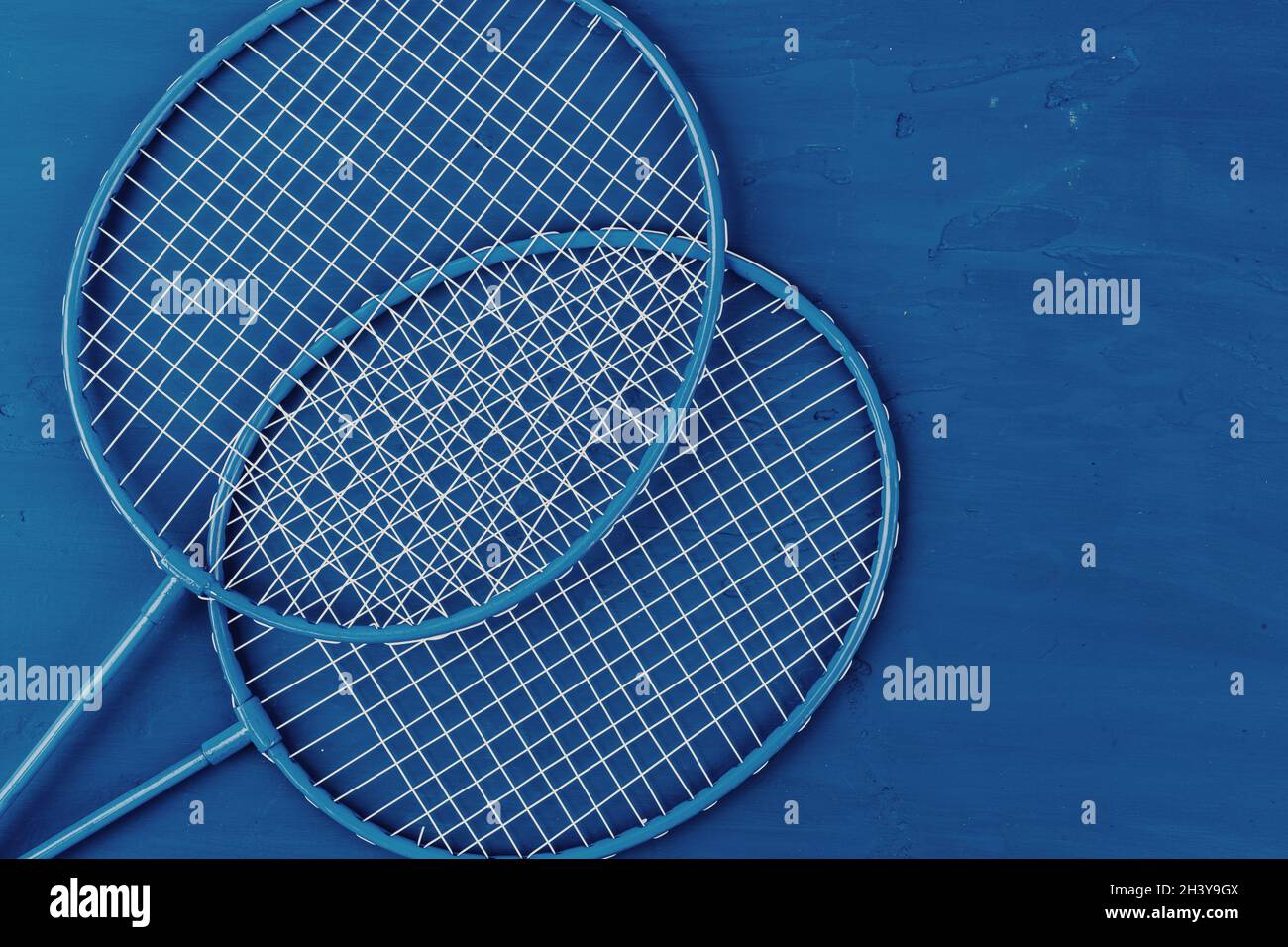 Badminton rackets on classic blue background, top view Stock Photo - Alamy