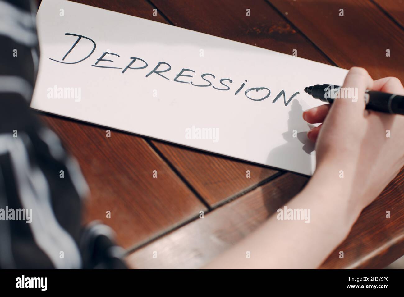 Woman hand writing word Depression on white sheet Stock Photo - Alamy