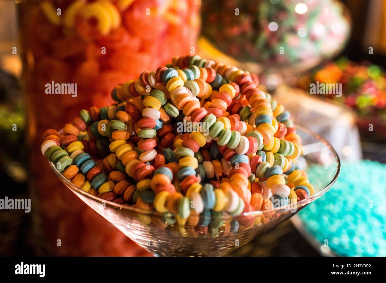 A glass bowl with colorful candies is on display at a party Stock Photo ...