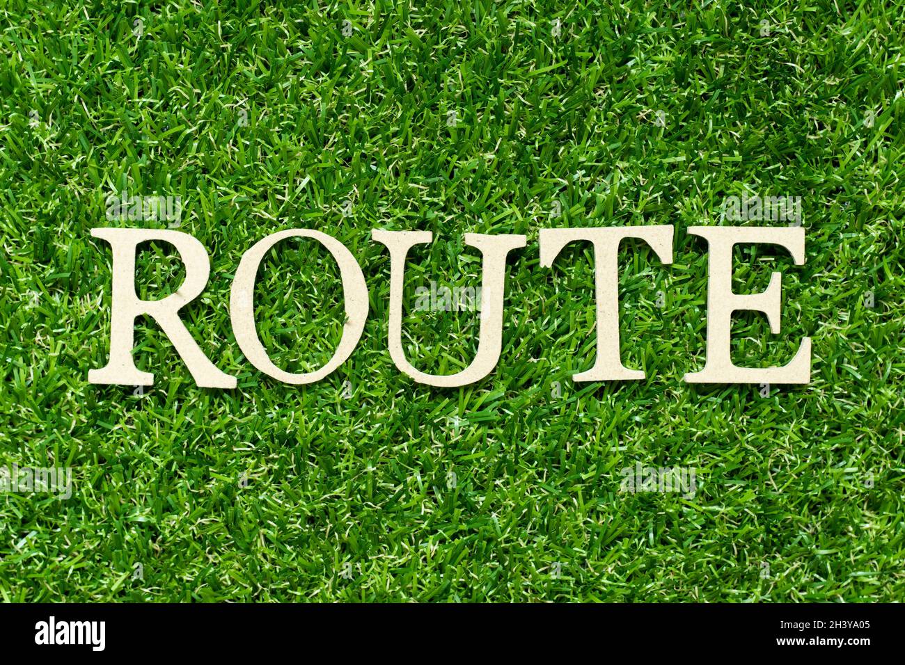 Wood letter in word route on green grass background Stock Photo - Alamy