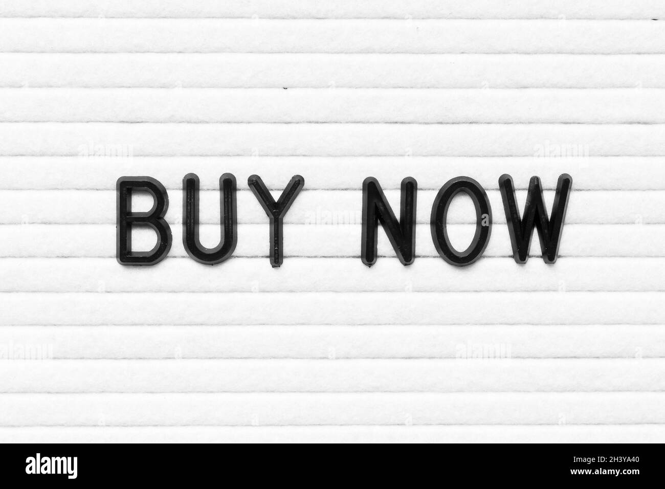 Black letter in word buy now on white felt board background Stock Photo ...