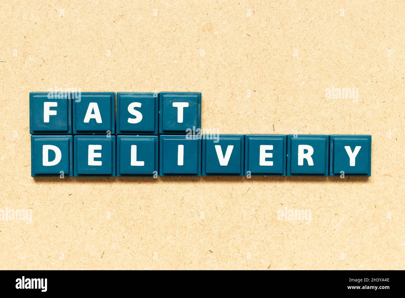 Tile alphabet letter in word fast delivery on wood background Stock ...