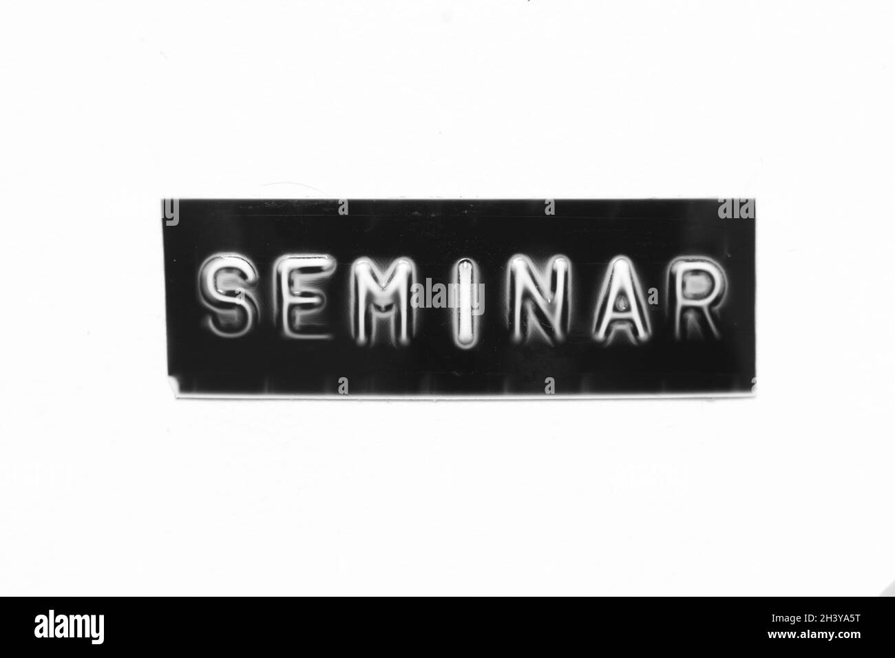 Black color banner that have embossed letter with word seminar on white ...
