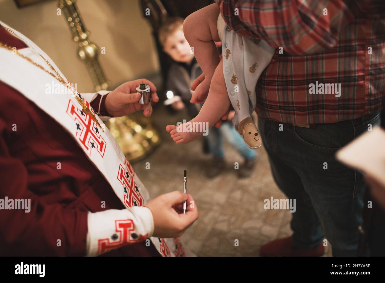 Orthodox Christian Priest and little child in the church. Epiphany ...