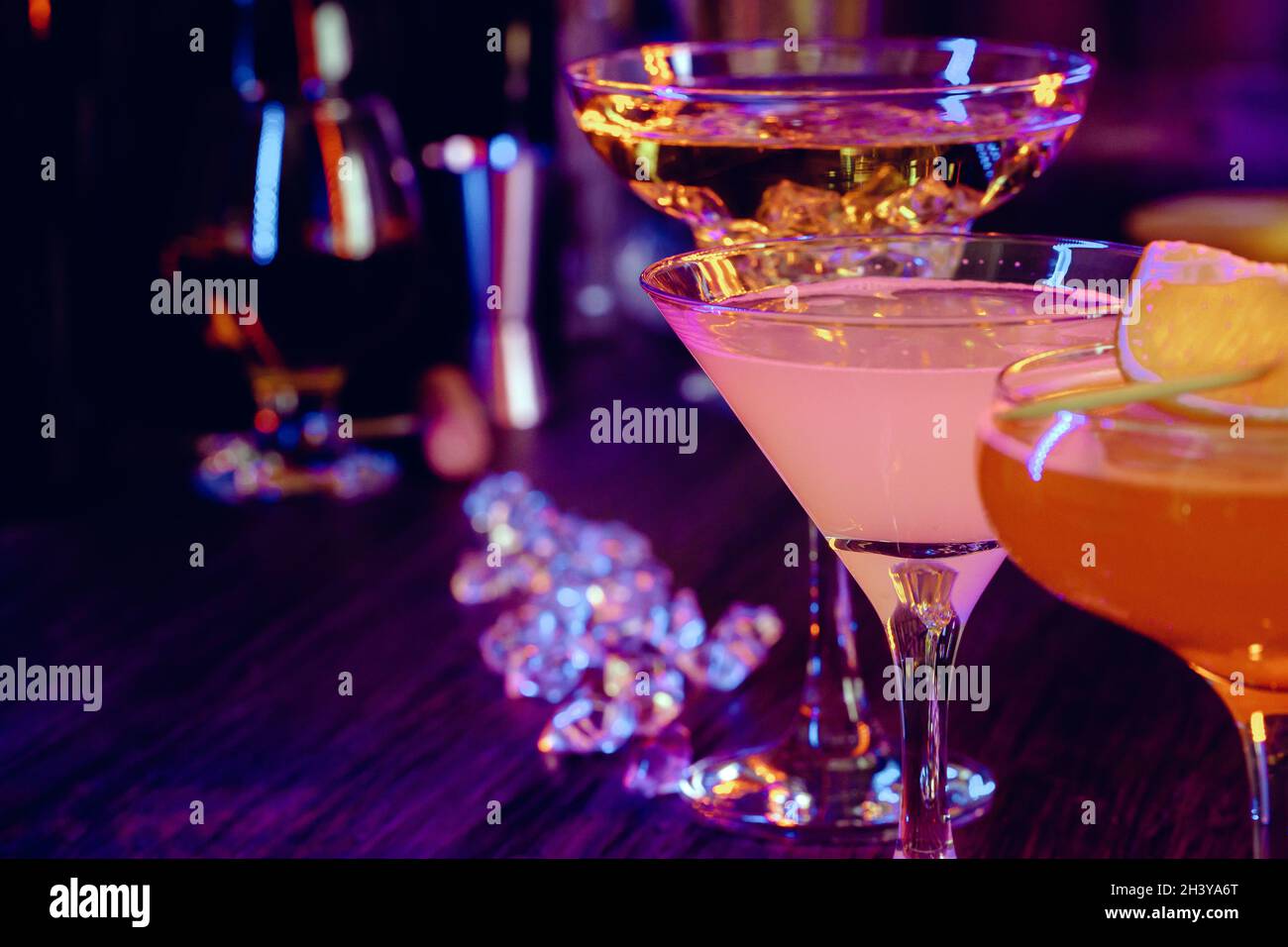 Two beautiful cocktails served on a wooden bar counter Stock Photo - Alamy