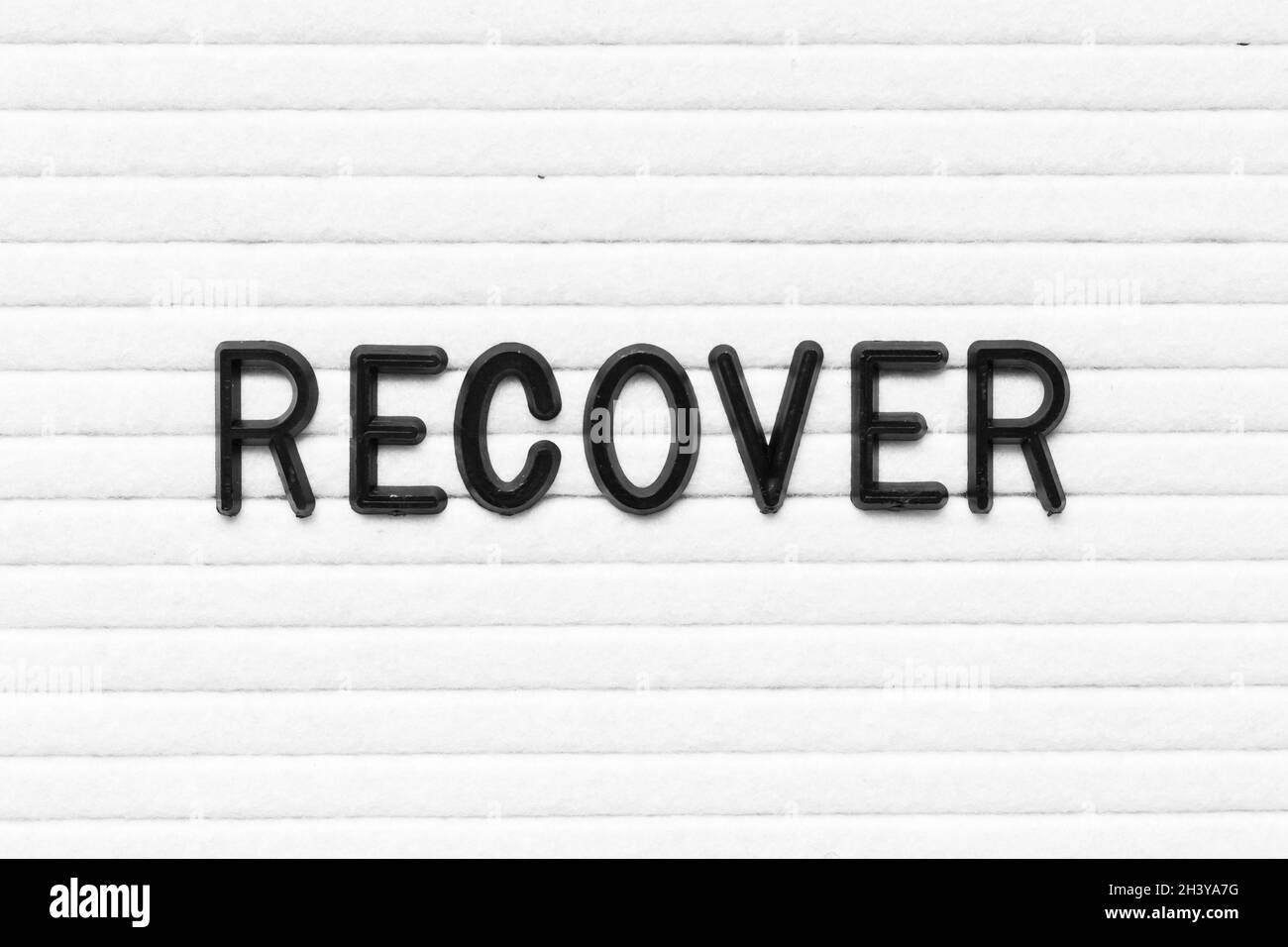 Black letter in word recover on white felt board background Stock Photo ...