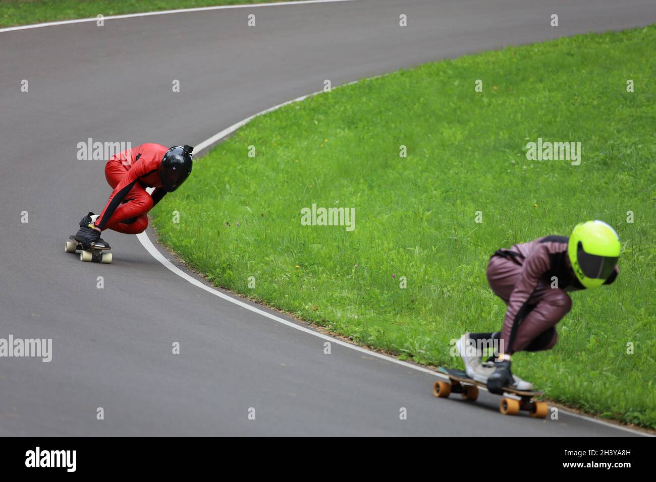 Longboard competition, athletes on the track in the middle of a forest ...