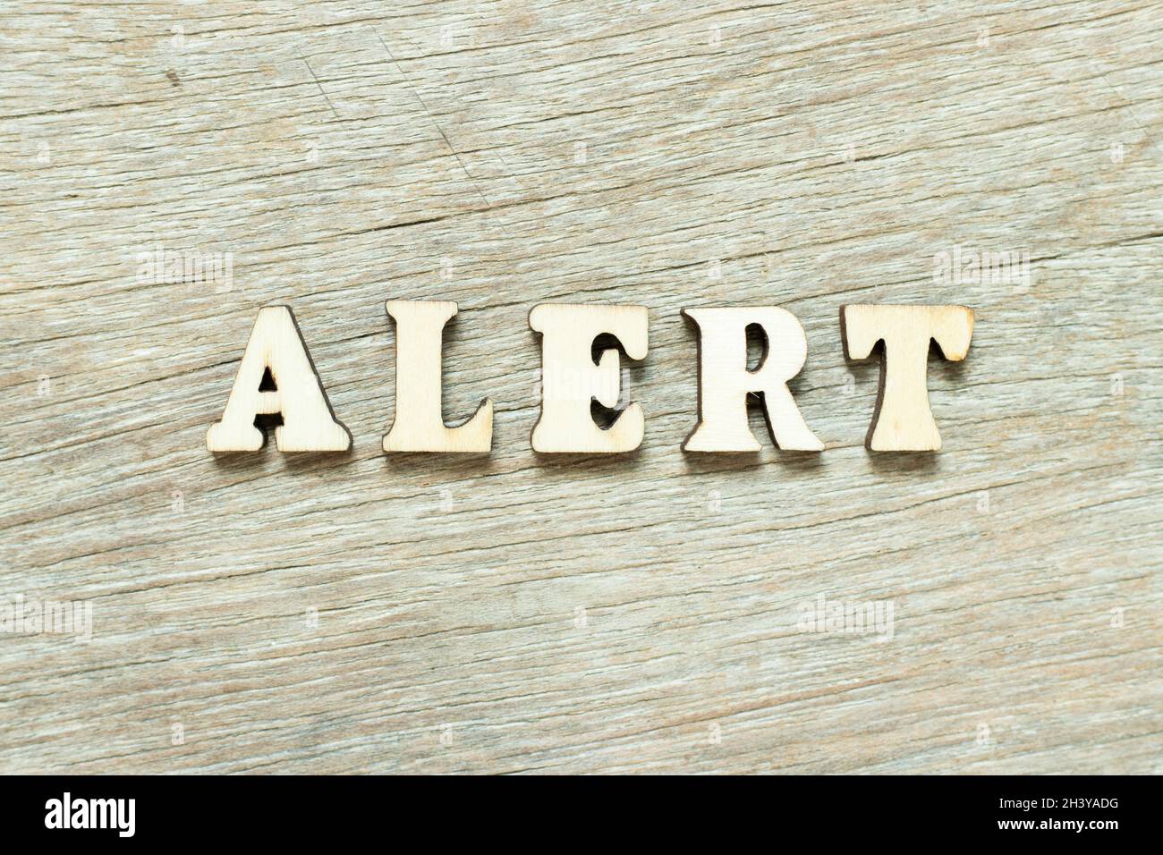 Alphabet letter in word alert on wood background Stock Photo - Alamy