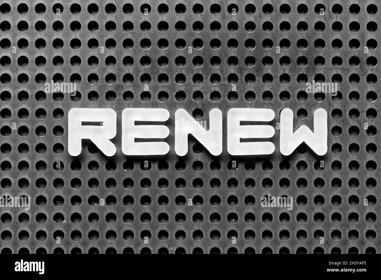 White alphabet letter in word renew on black pegboard background Stock ...