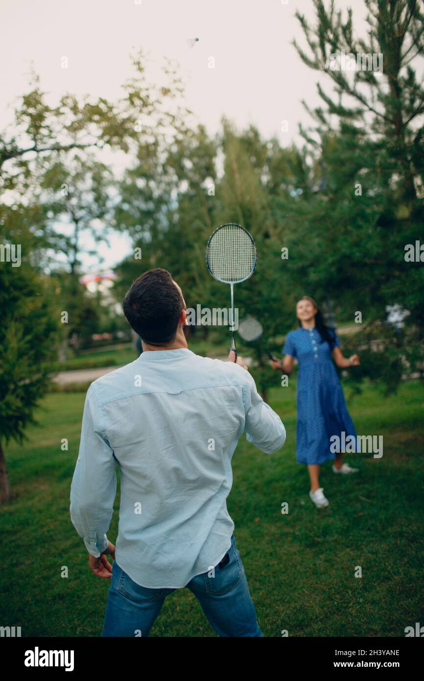 Young adult couple playing badminton in the park Stock Photo - Alamy