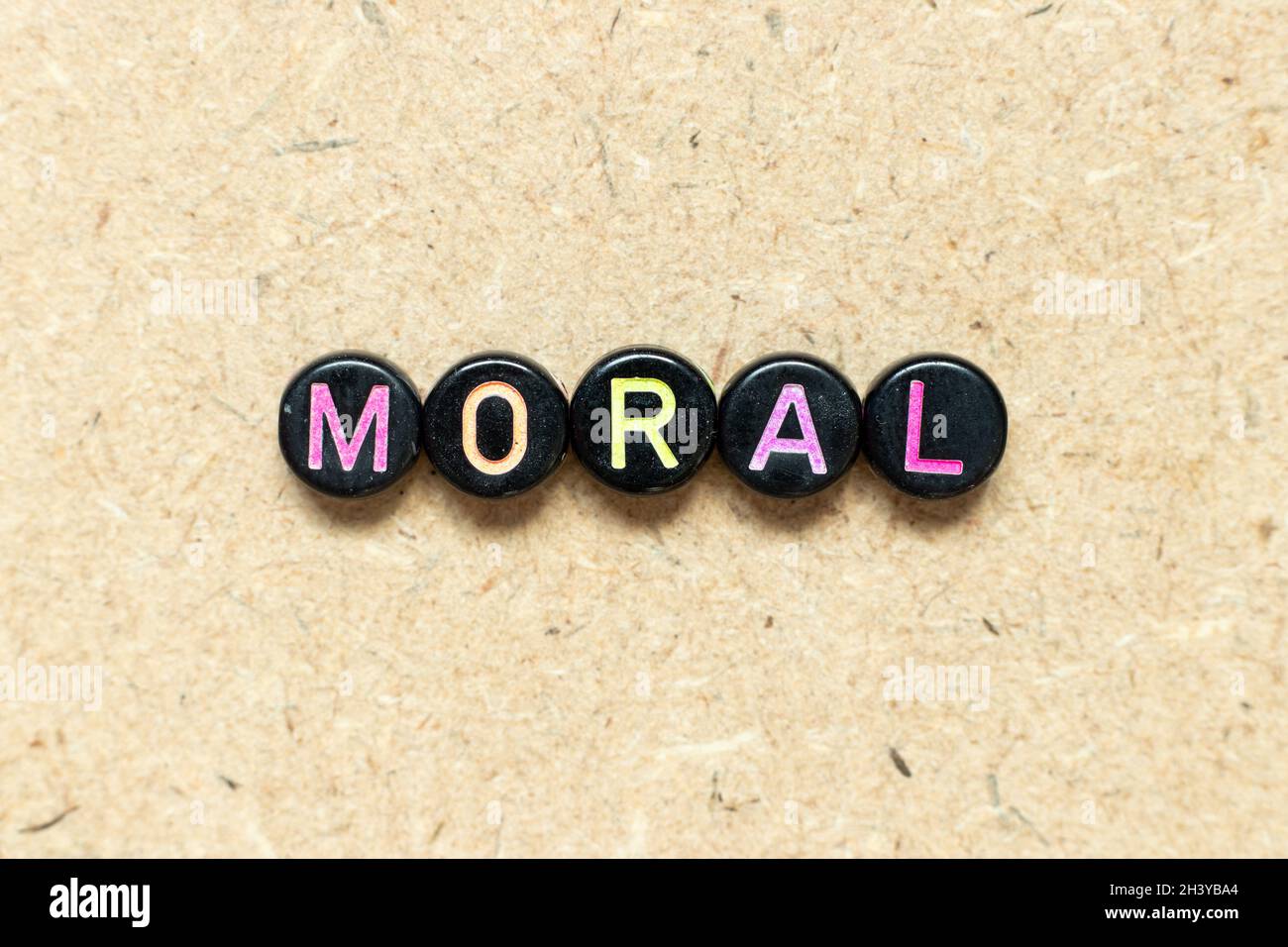 Black color round bead in word moral on wood background Stock Photo - Alamy