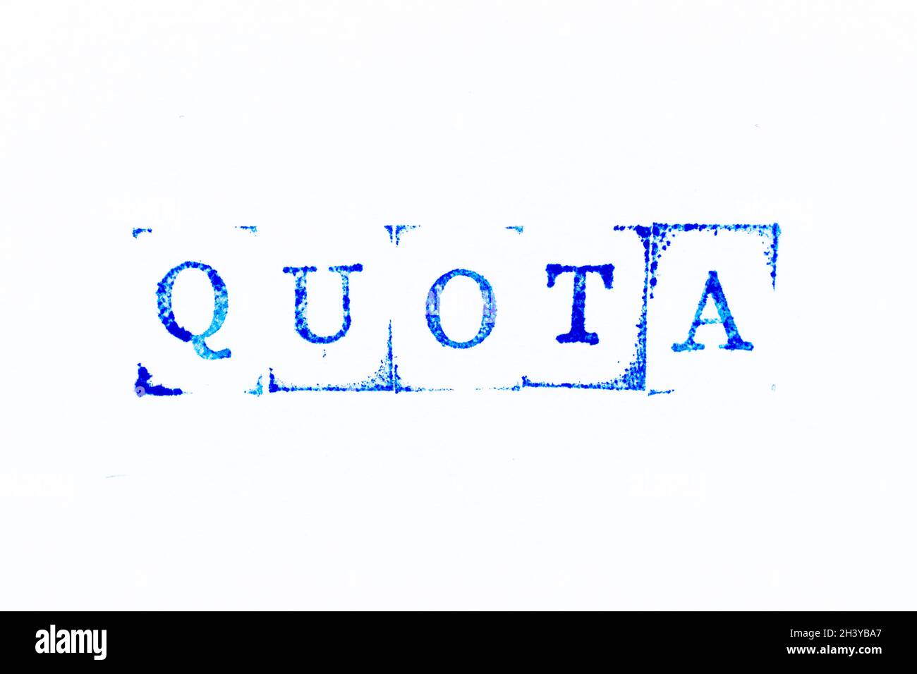 Blue color ink rubber stamp in word quota on white paper background ...
