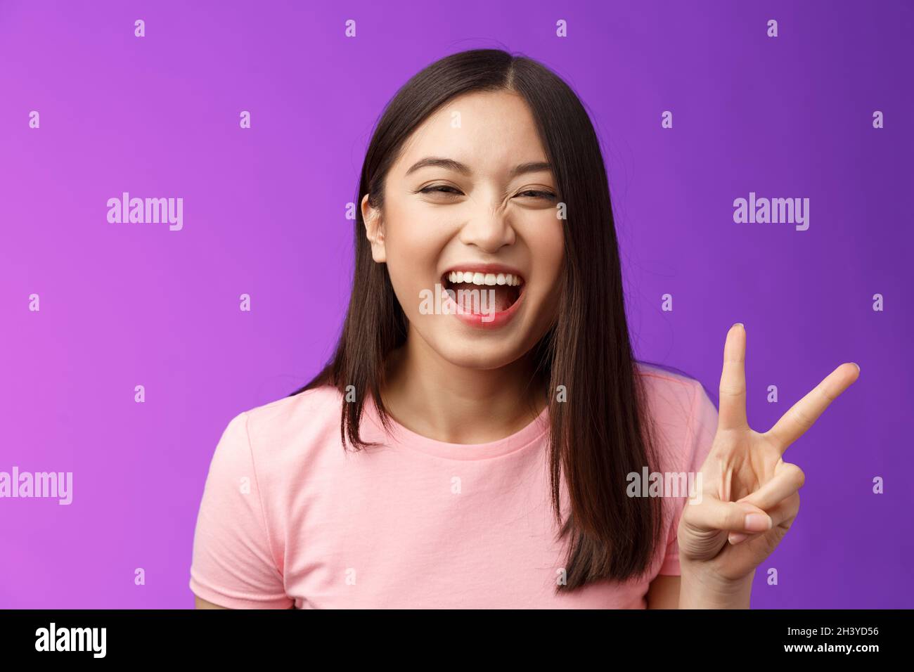 Headshot sincere carefree laughing asian girl having fun, show peace ...