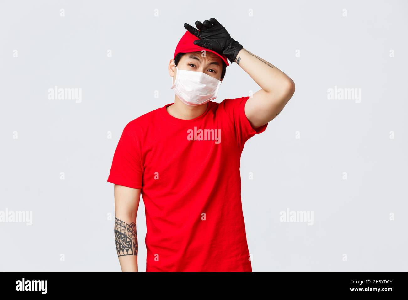 Phew hard work of couriers. Tired asian delivery guy in medical mask ...