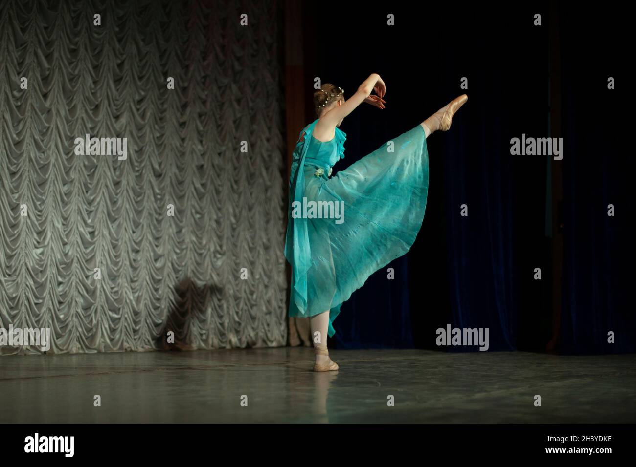 The ballerina dances on stage. Dance lesson in the hall. A girl in a ...