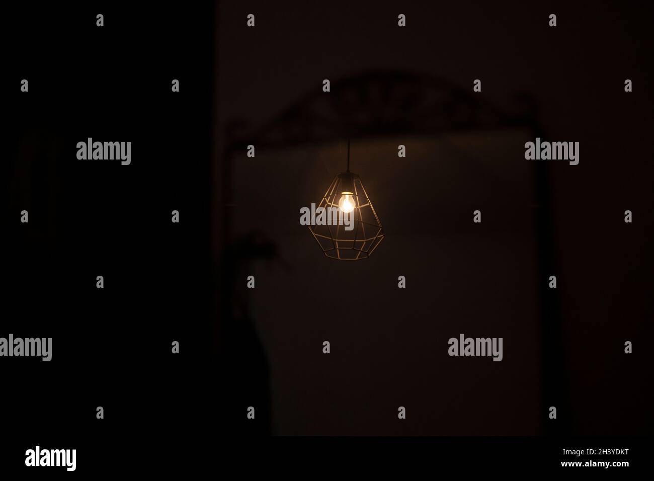 A lamp in a dark room. The gloomy lighting of the room. A dim light in ...