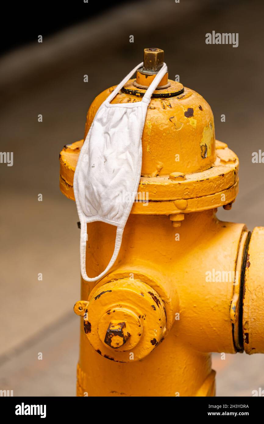 Photo of an abandoned face mask hanging on a fire hydrant Stock Photo ...