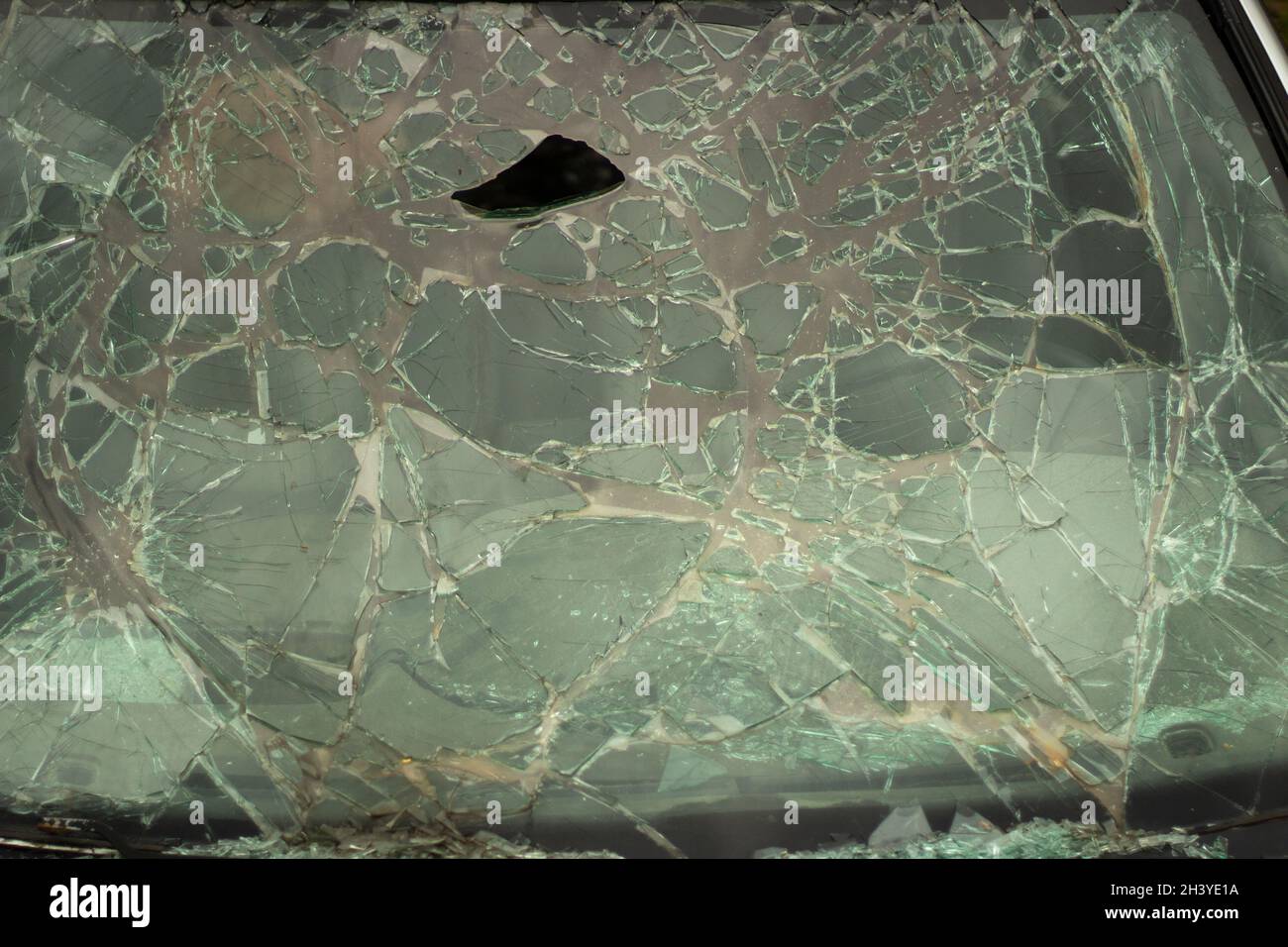 Broken glass in detail. Car windshield after the accident. Lots of ...