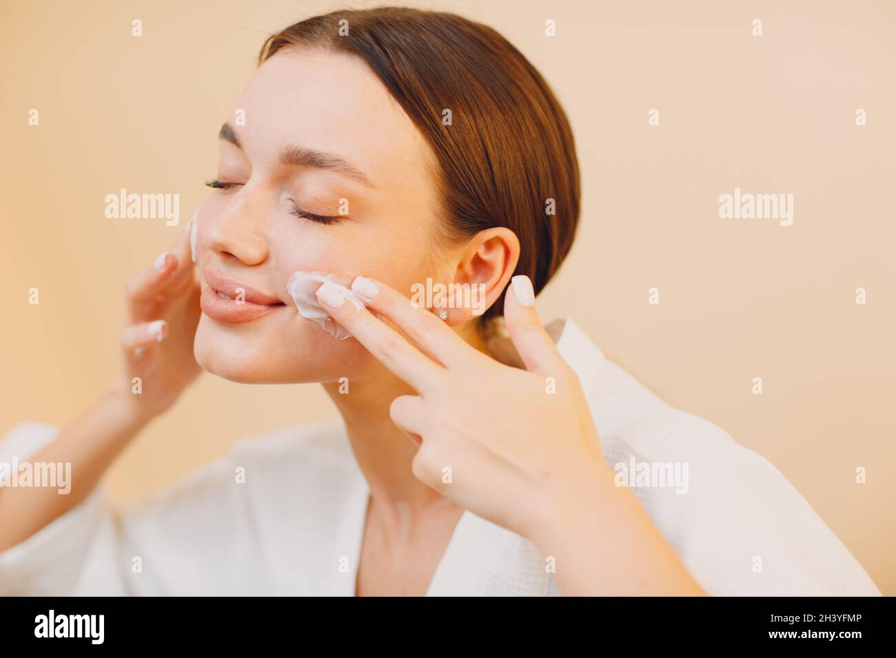 Woman applying cream and face hi-res stock photography and images - Alamy