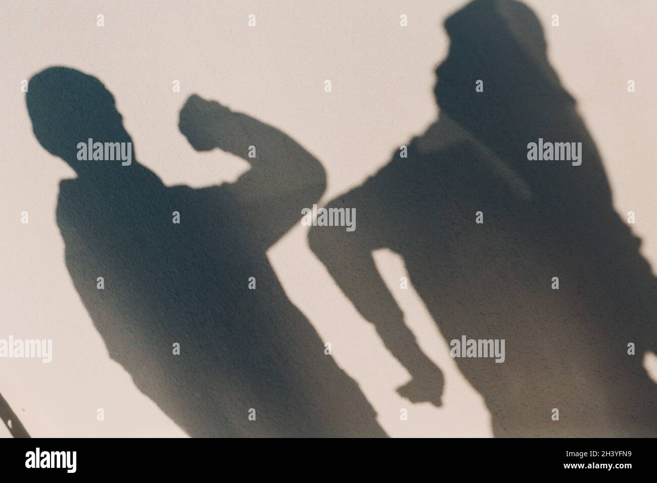 Elbow bumping safety greeting of two people shadow on wall of ...
