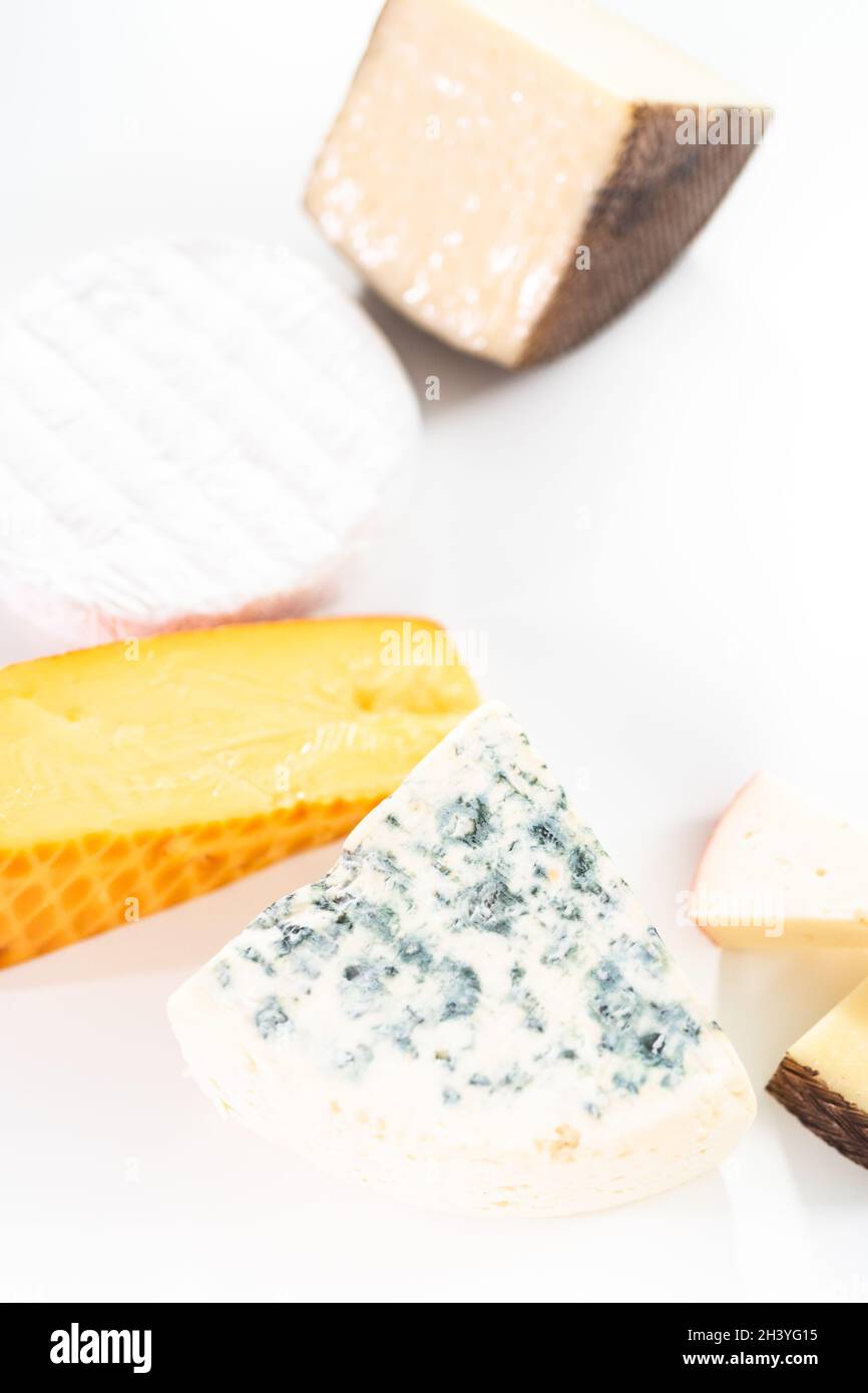 Variety of large wedges gourmet cheese on a white background Stock ...