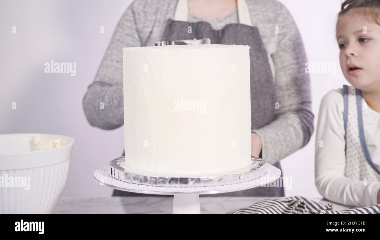 Step by step. Frosting round funfetti cake with white italian ...