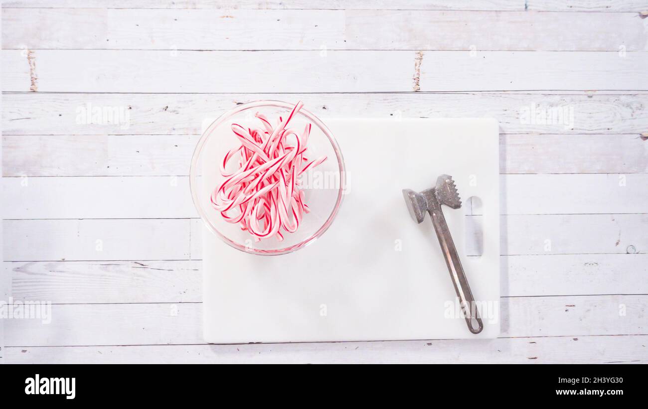 Flat lay. Step by step. Breaking candy cane candies into small pieces ...