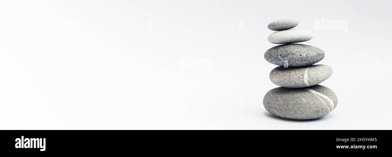 Stone cairn on light background, stones tower, simple poise stones. Purity harmony and Balance ...