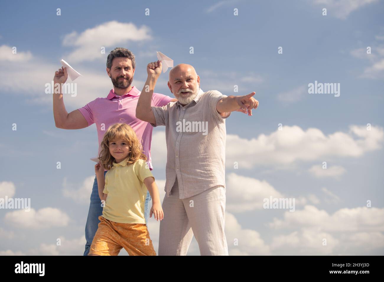 Men generation: grandfather father and grandson playing with toy plane ...