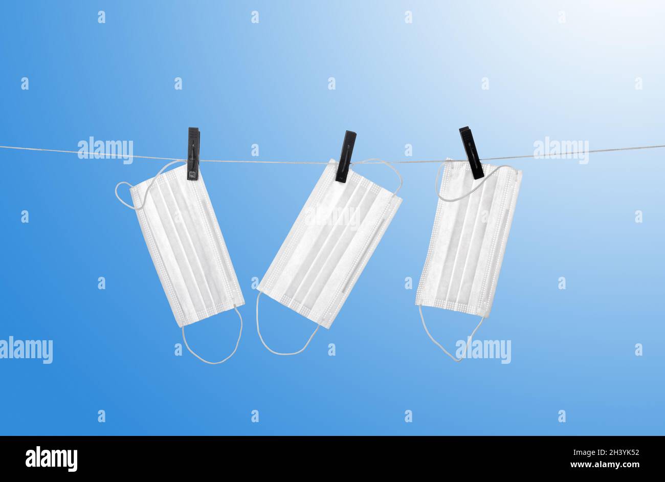 Medical masks on a rope Stock Photo - Alamy